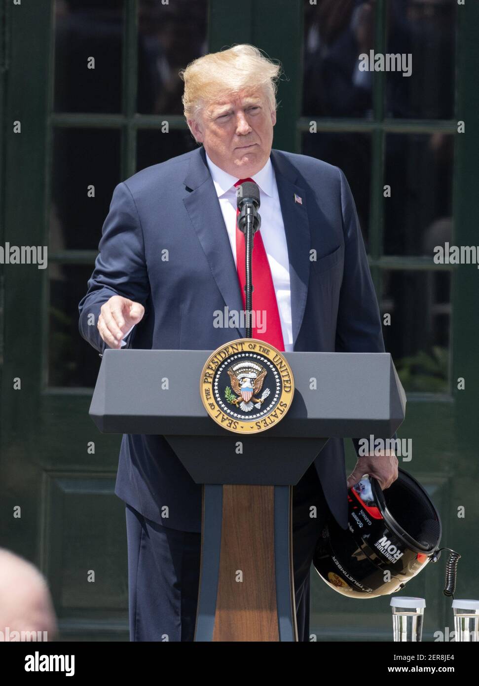 United States President Donald J. Trump holds the racing helmet he ...