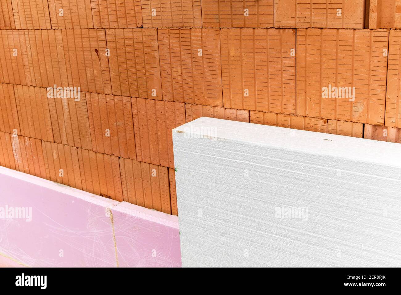 External thermal insulation of a building on a construction site with ...