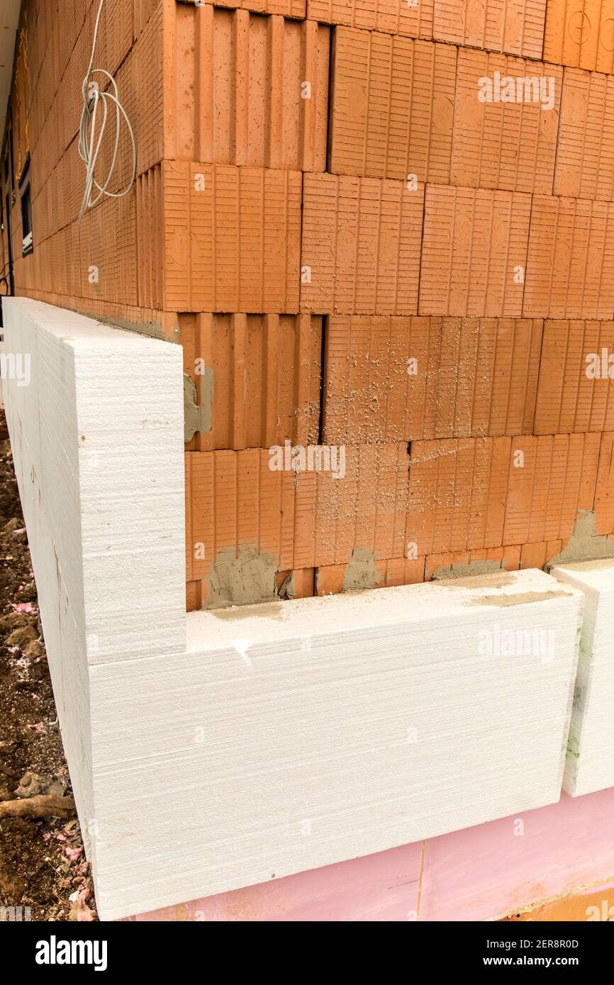 External thermal insulation of a building on a construction site with ...