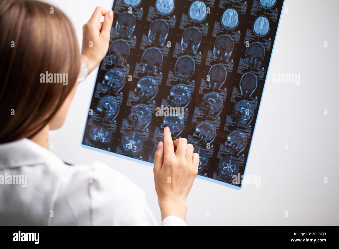 Beautiful female radiologist looking at the MRI scan images Stock Photo ...