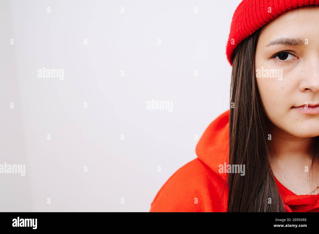 half face of a girl dressed in all red Stock Photo - Alamy