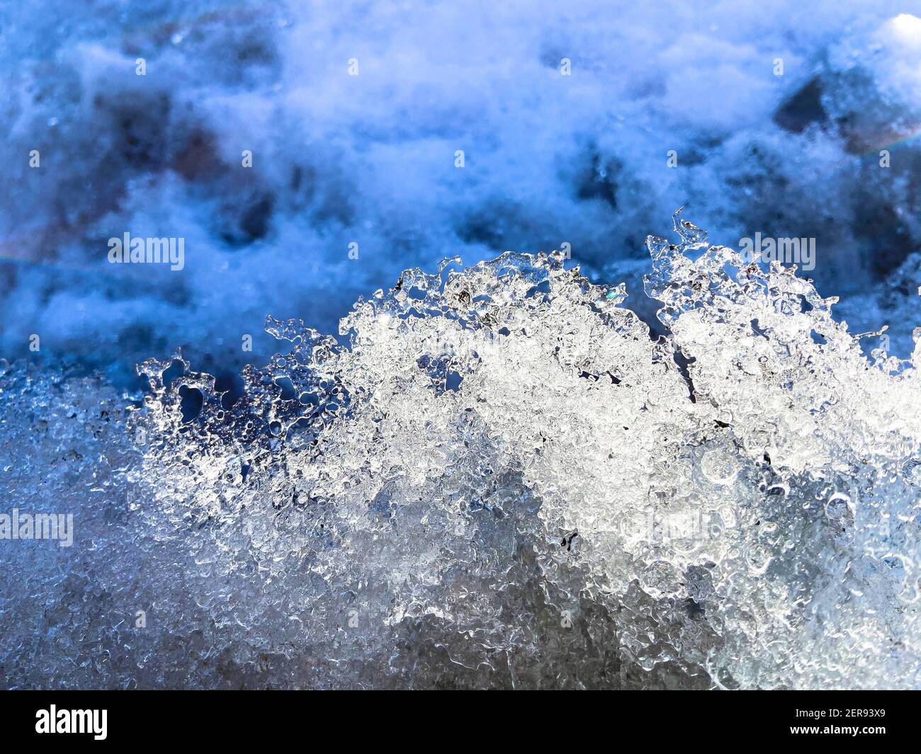 Frozen snow with blue icy background Stock Photo - Alamy