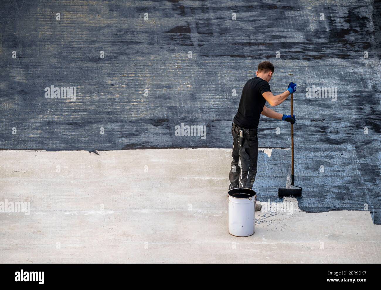 Construction site, application of a bituminous coating on a concrete ceiling, preparation for ...