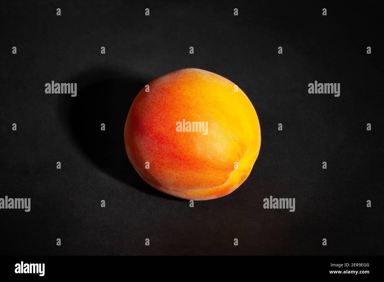 one apricot on black background Stock Photo - Alamy