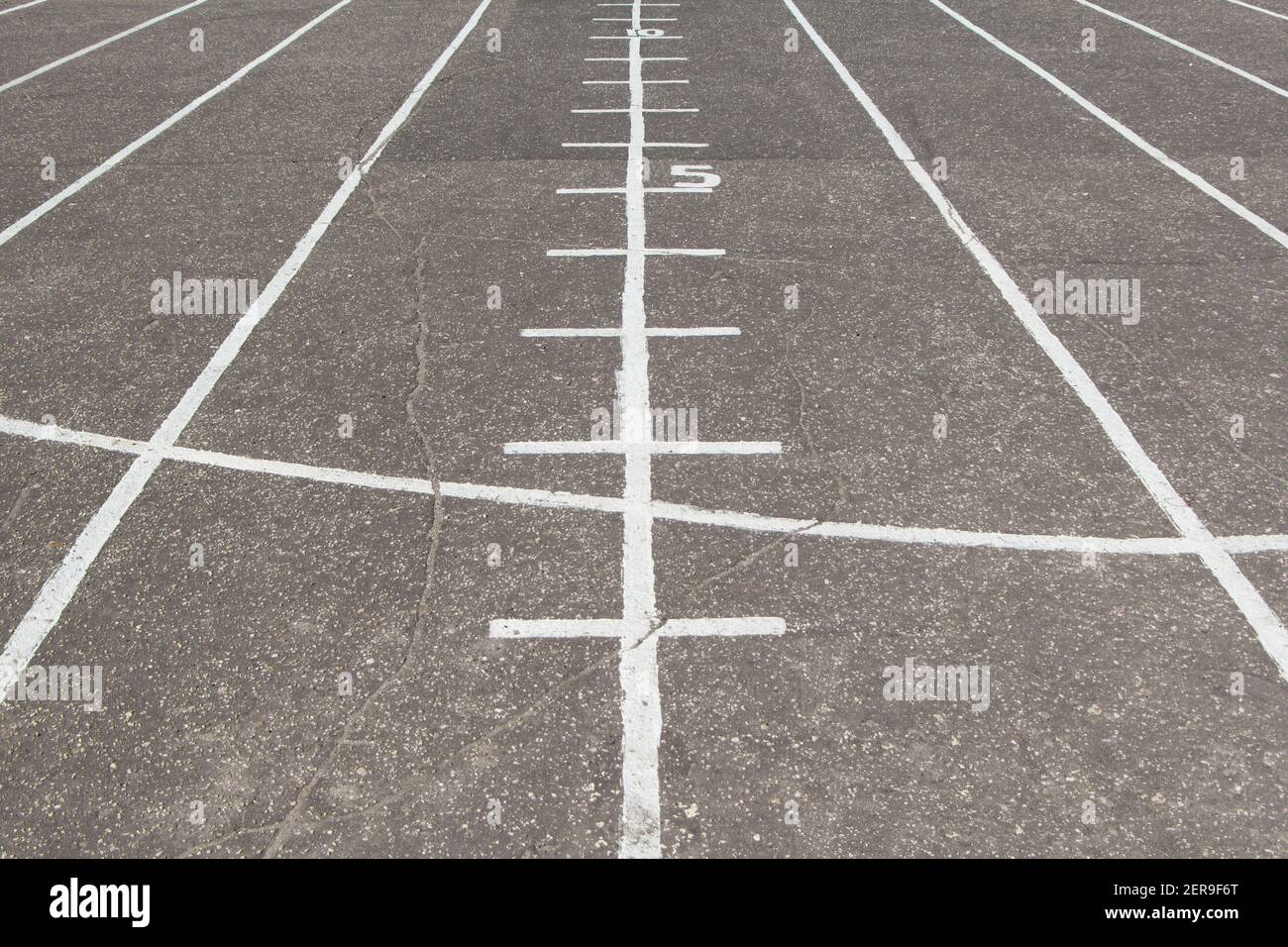 Sport marking on old asphalt, white lines with numbers Stock Photo - Alamy