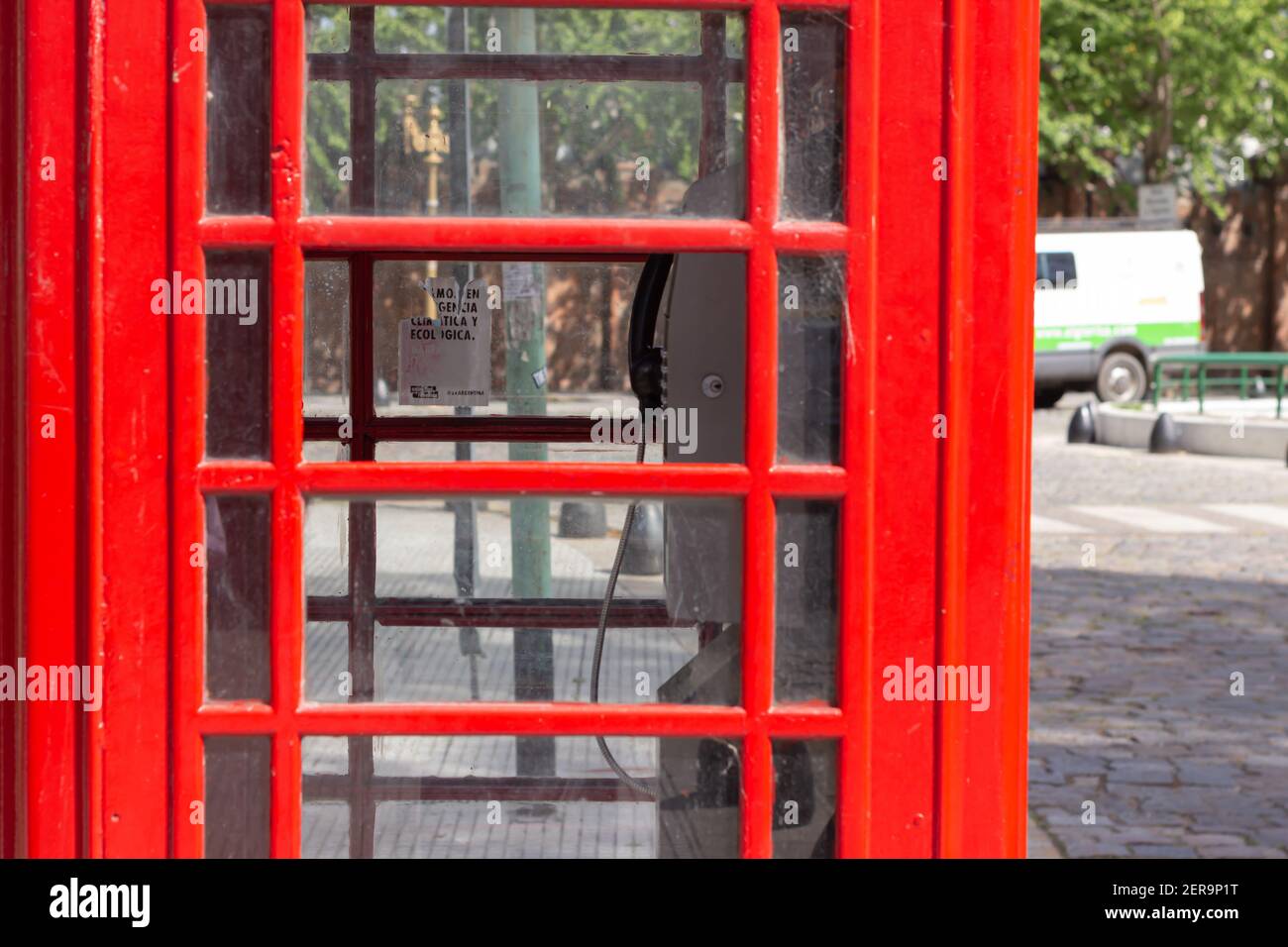 Old public phone in a red booth Stock Photo - Alamy