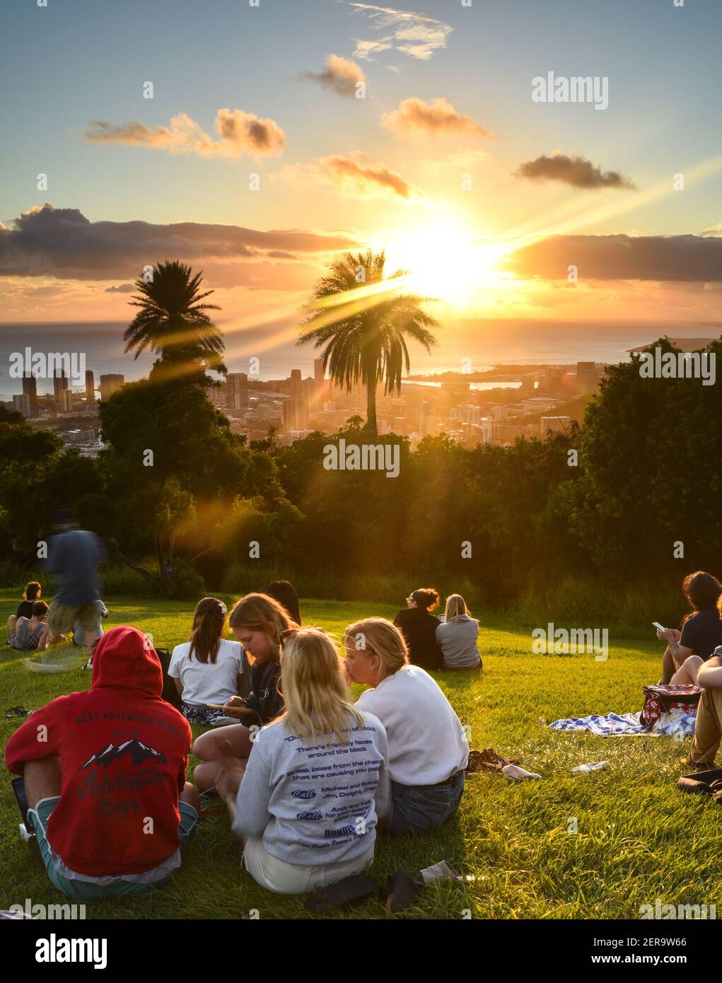 Tourists and Hawaiian people gathered to watch sunset from lookout at ...