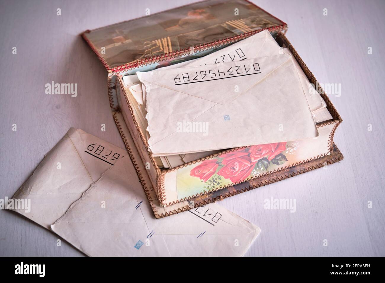 An old handmade cardboard box with paper letters from yesteryear. Retro ...