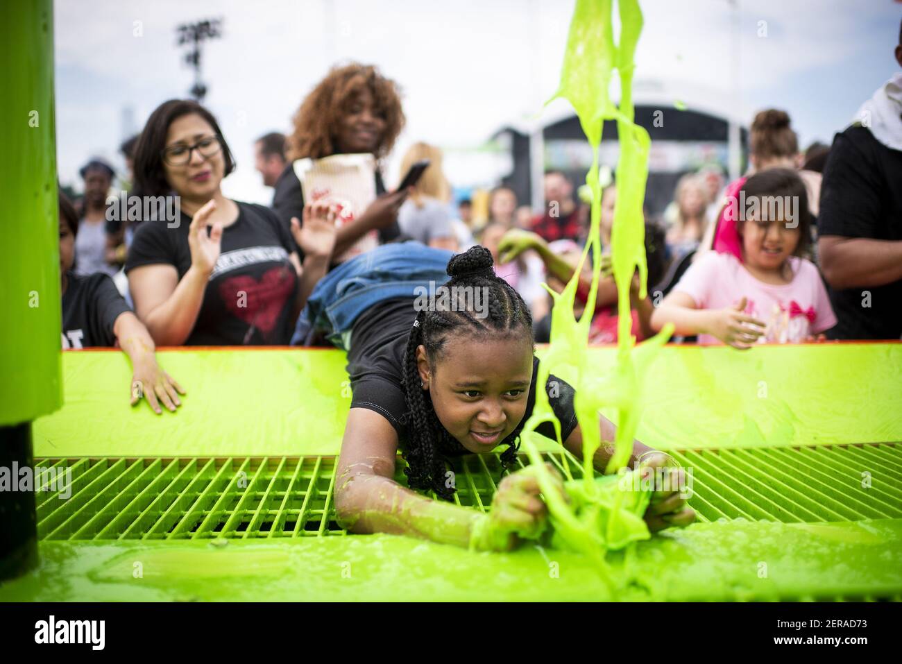 An attendee collects a bag of "slime" at the Nickelodeon SlimeFest on ...