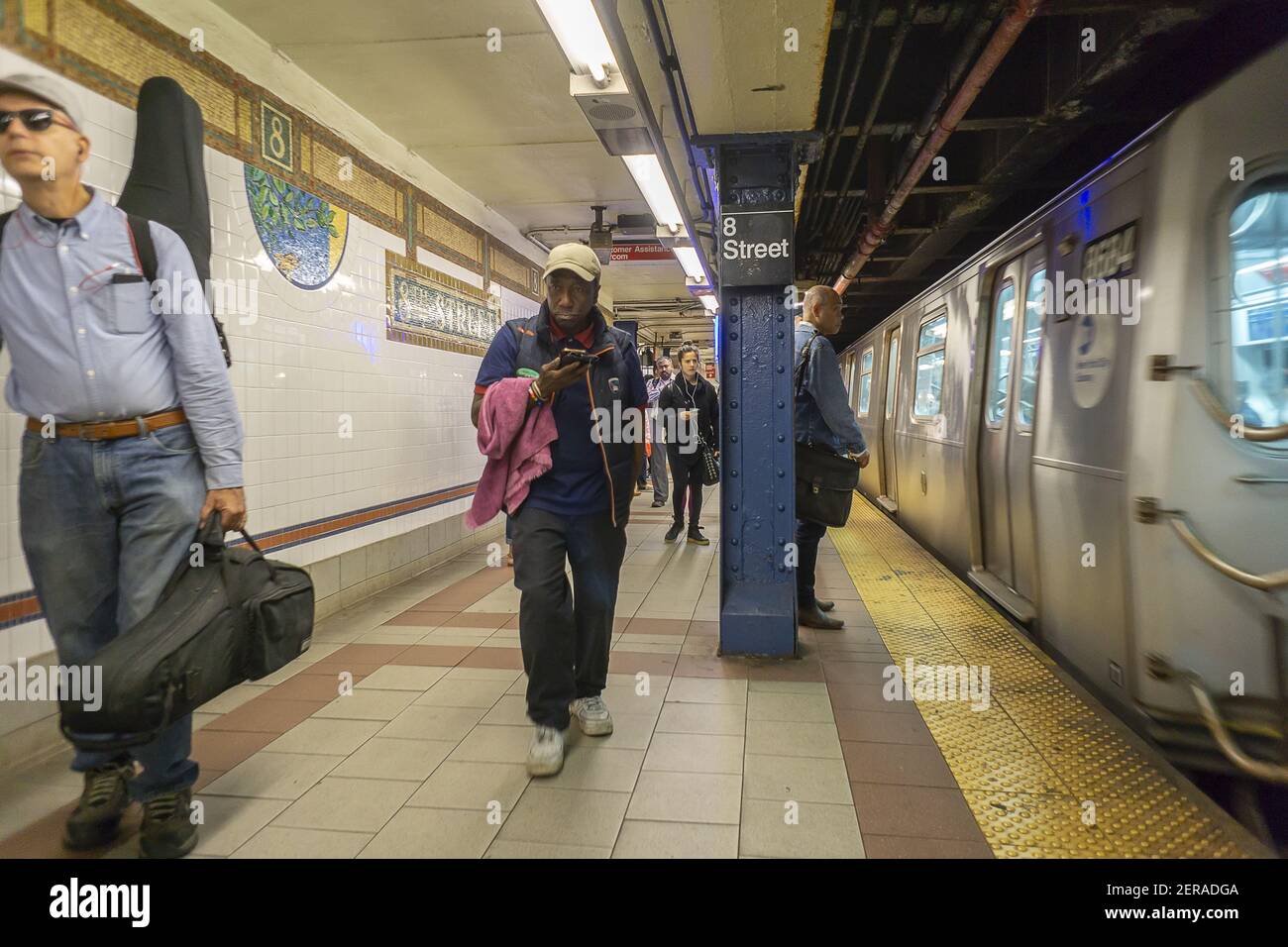 Weekend subway riders wait for a train at the 8th Street station in the ...