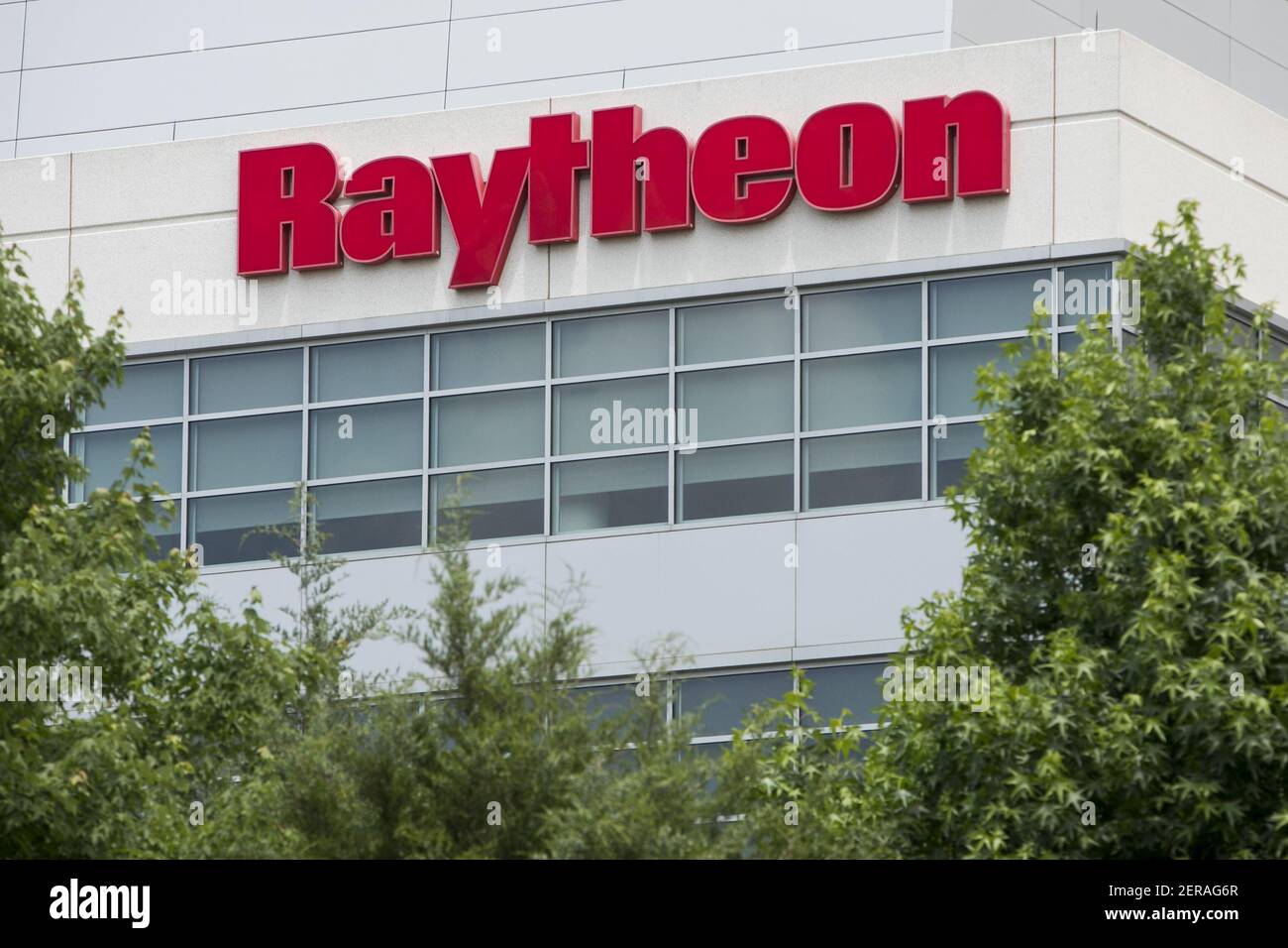 A logo sign outside of a facility occupied by The Raytheon Company in ...