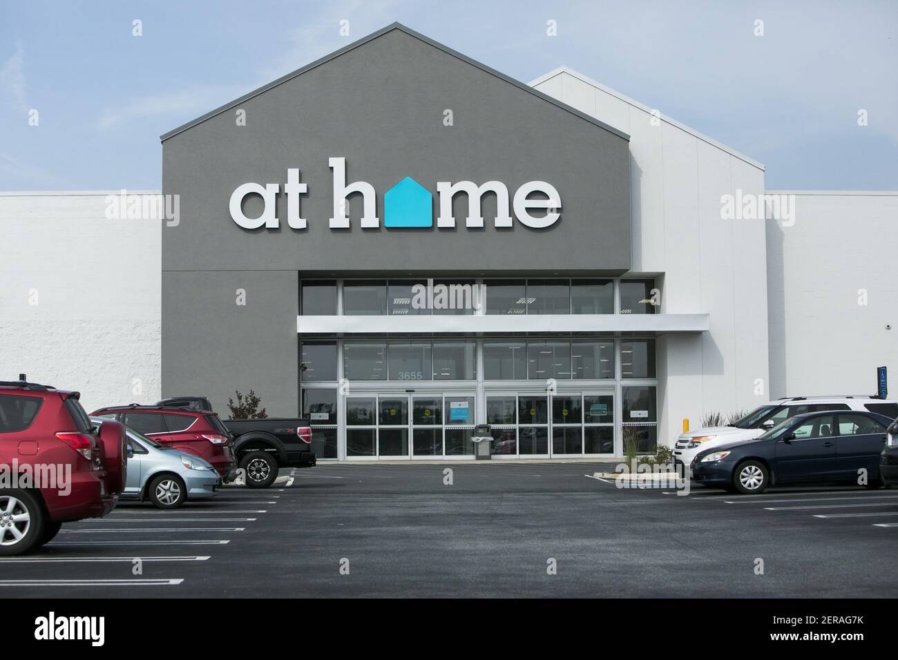 A logo sign outside of a At Home retail store in Fredericksburg ...