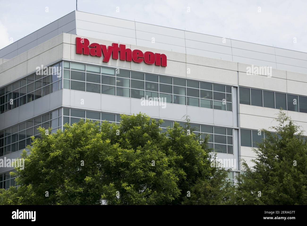 A logo sign outside of a facility occupied by The Raytheon Company in ...