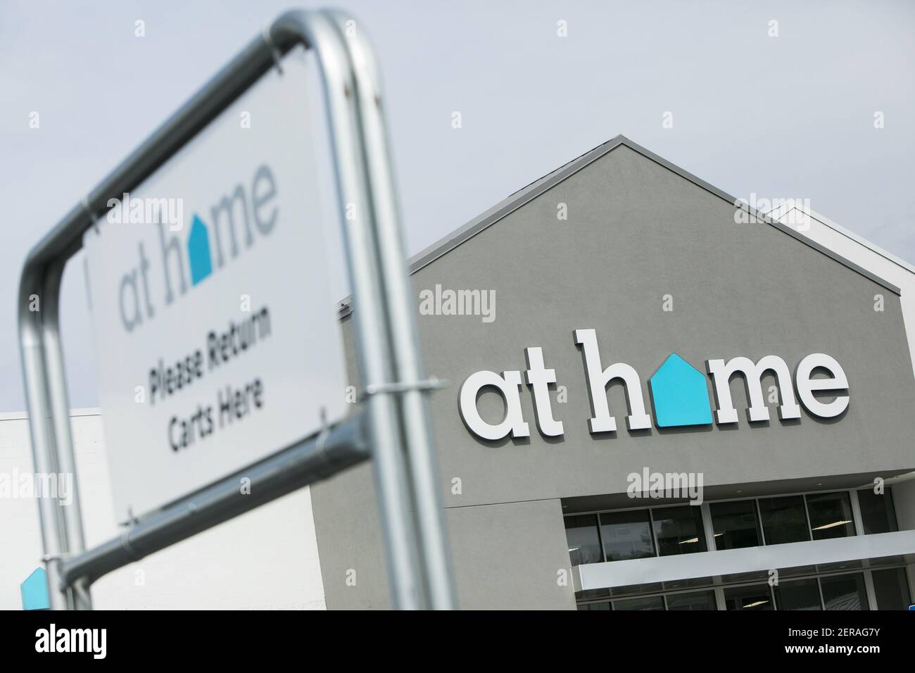 A logo sign outside of a At Home retail store in Fredericksburg ...
