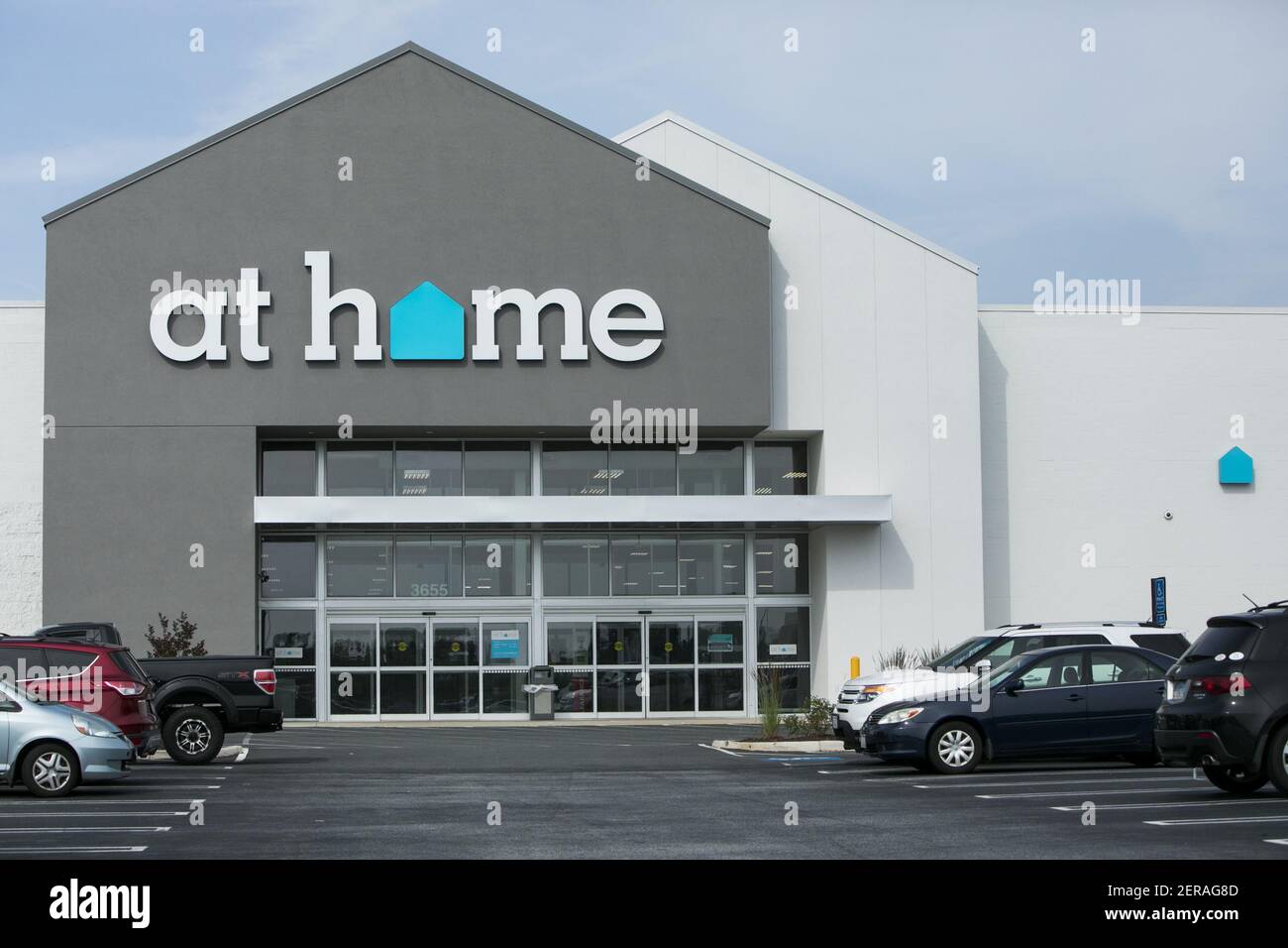 A logo sign outside of a At Home retail store in Fredericksburg ...