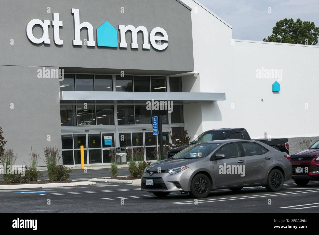A logo sign outside of a At Home retail store in Fredericksburg ...