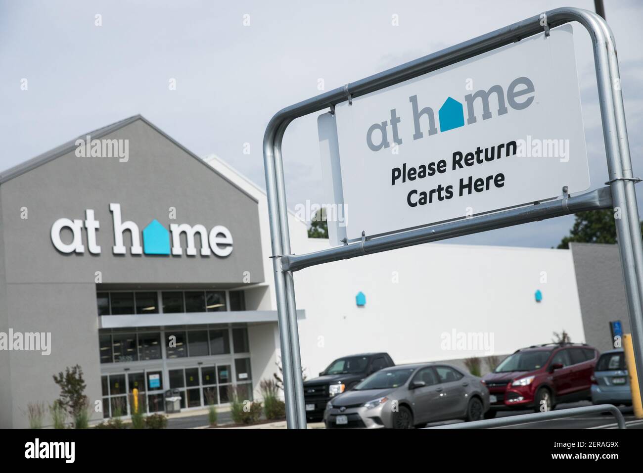 A logo sign outside of a At Home retail store in Fredericksburg ...