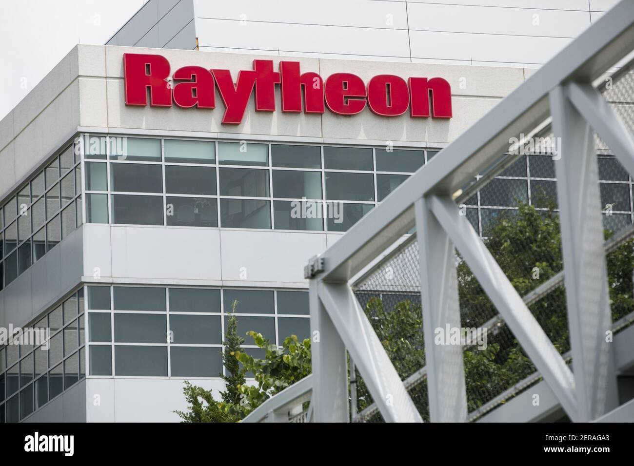 A logo sign outside of a facility occupied by The Raytheon Company in ...