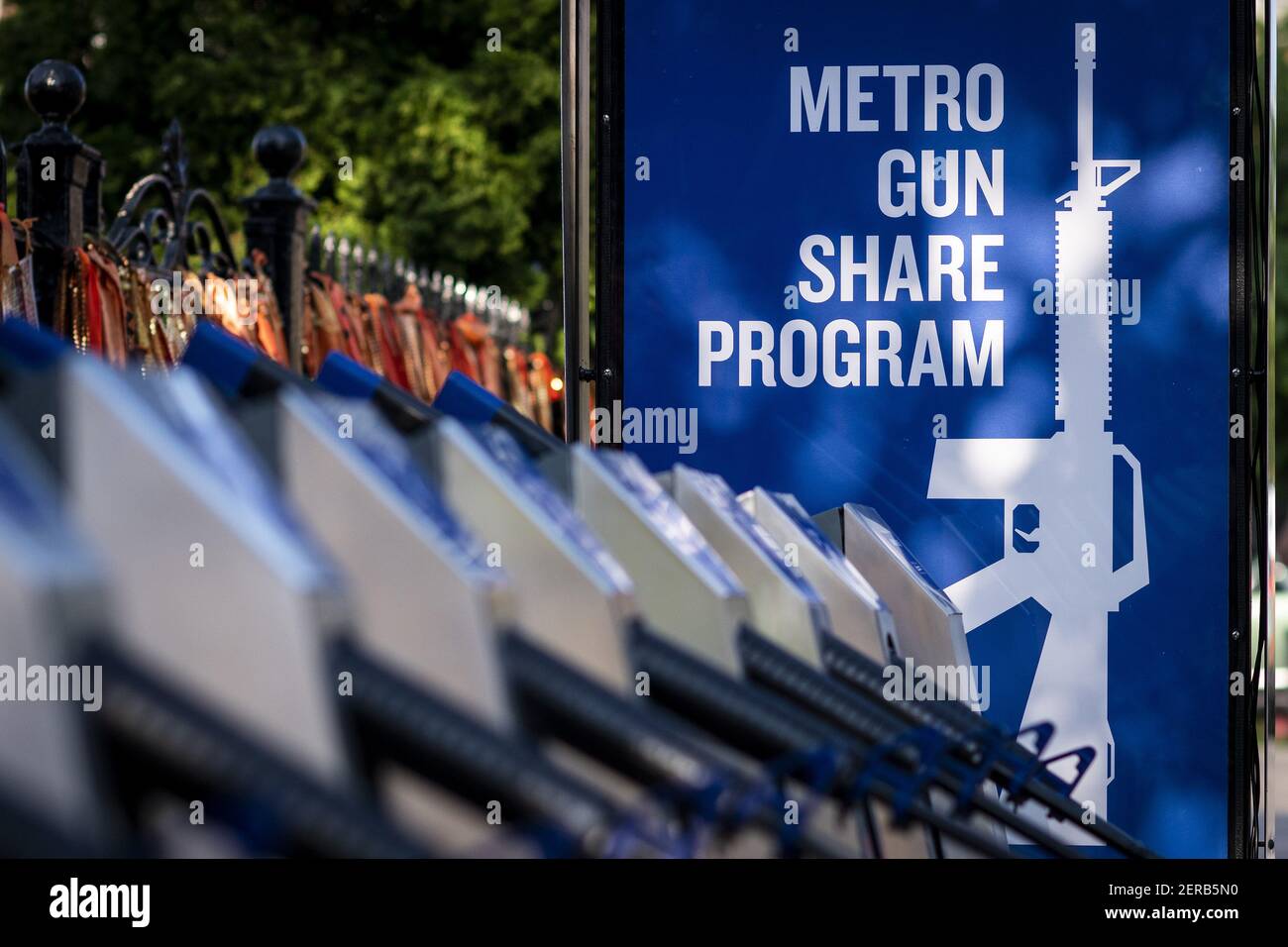 An art installation of mock AR-15 rifles, designed in a manner similar ...