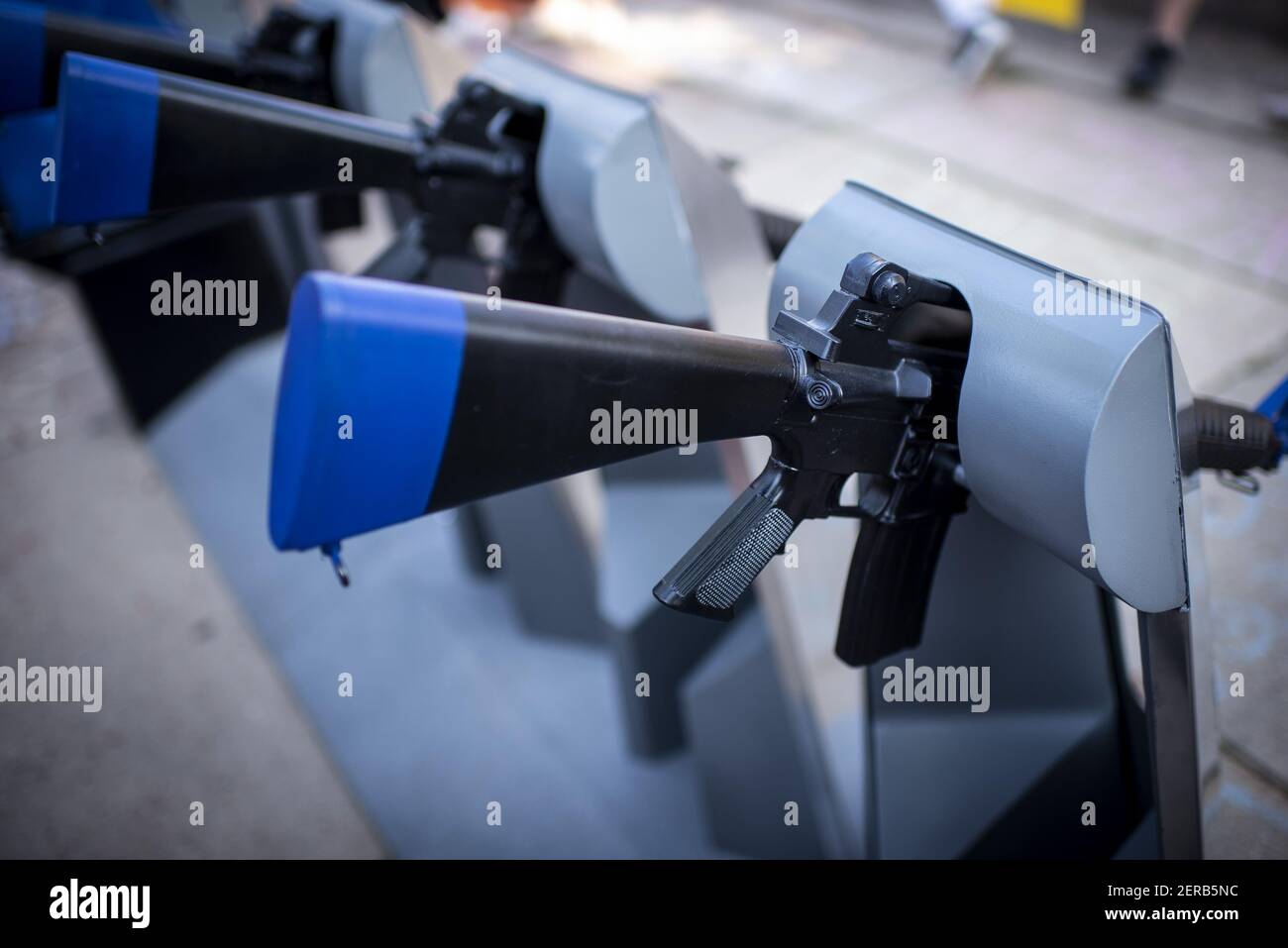 An art installation of mock AR-15 rifles, designed in a manner similar ...