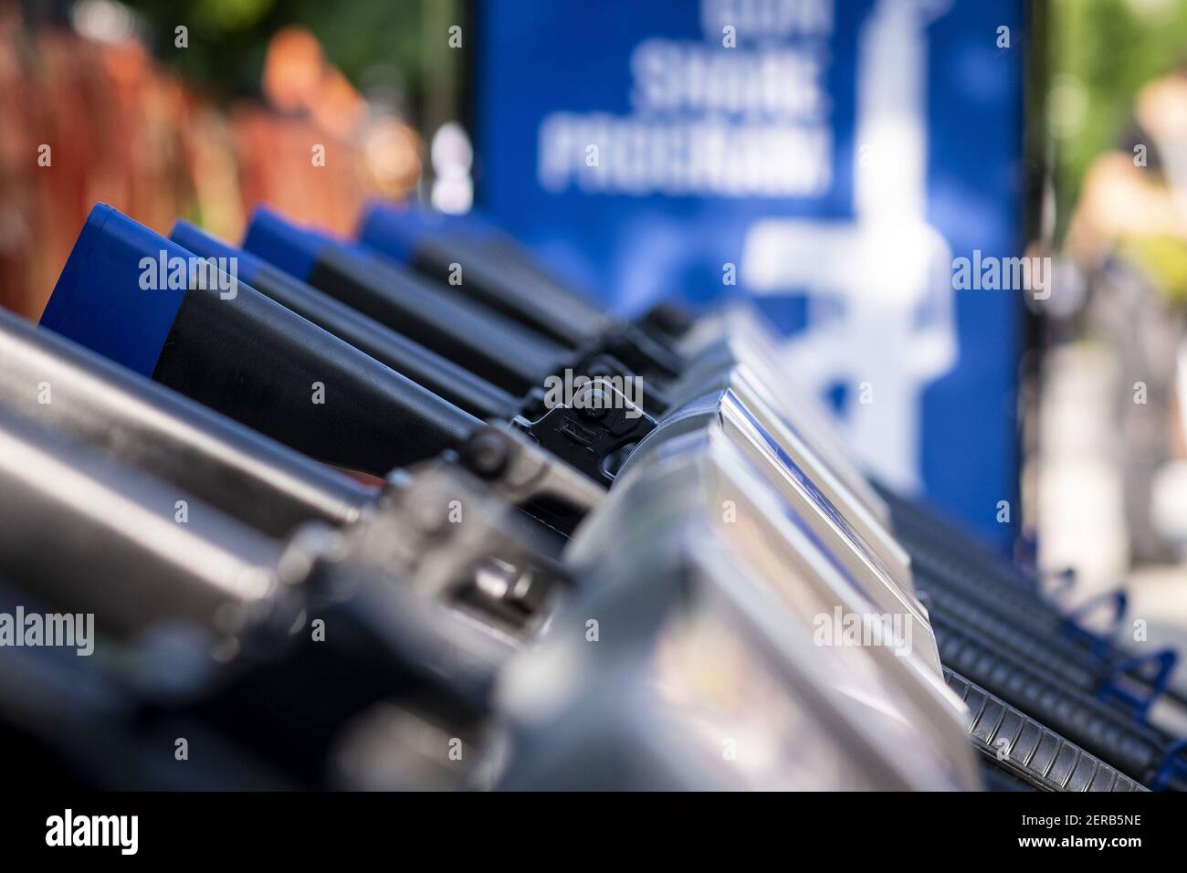 An art installation of mock AR-15 rifles, designed in a manner similar ...