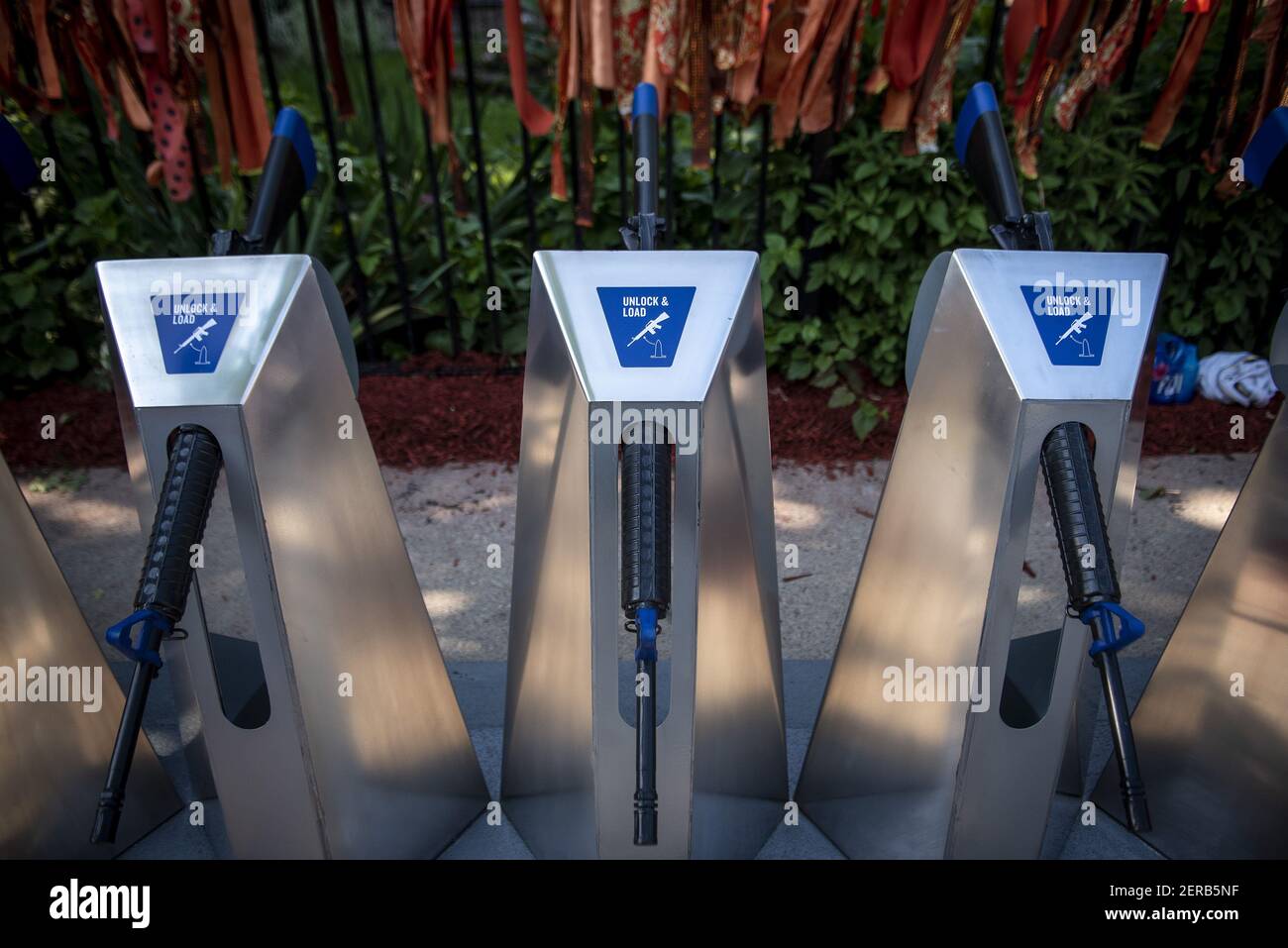An art installation of mock AR-15 rifles, designed in a manner similar ...