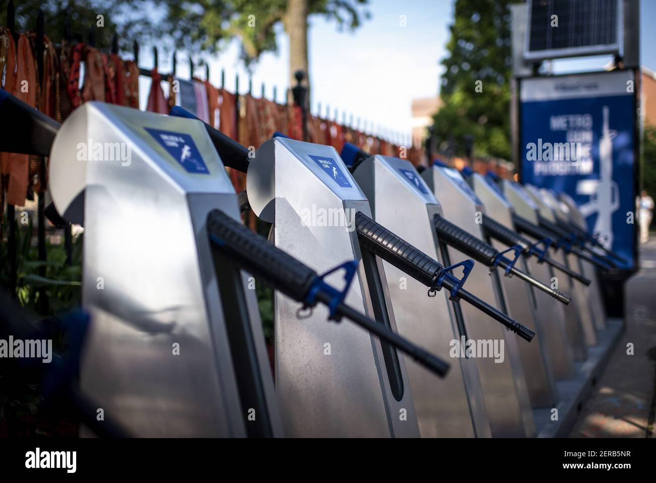An art installation of mock AR-15 rifles, designed in a manner similar ...