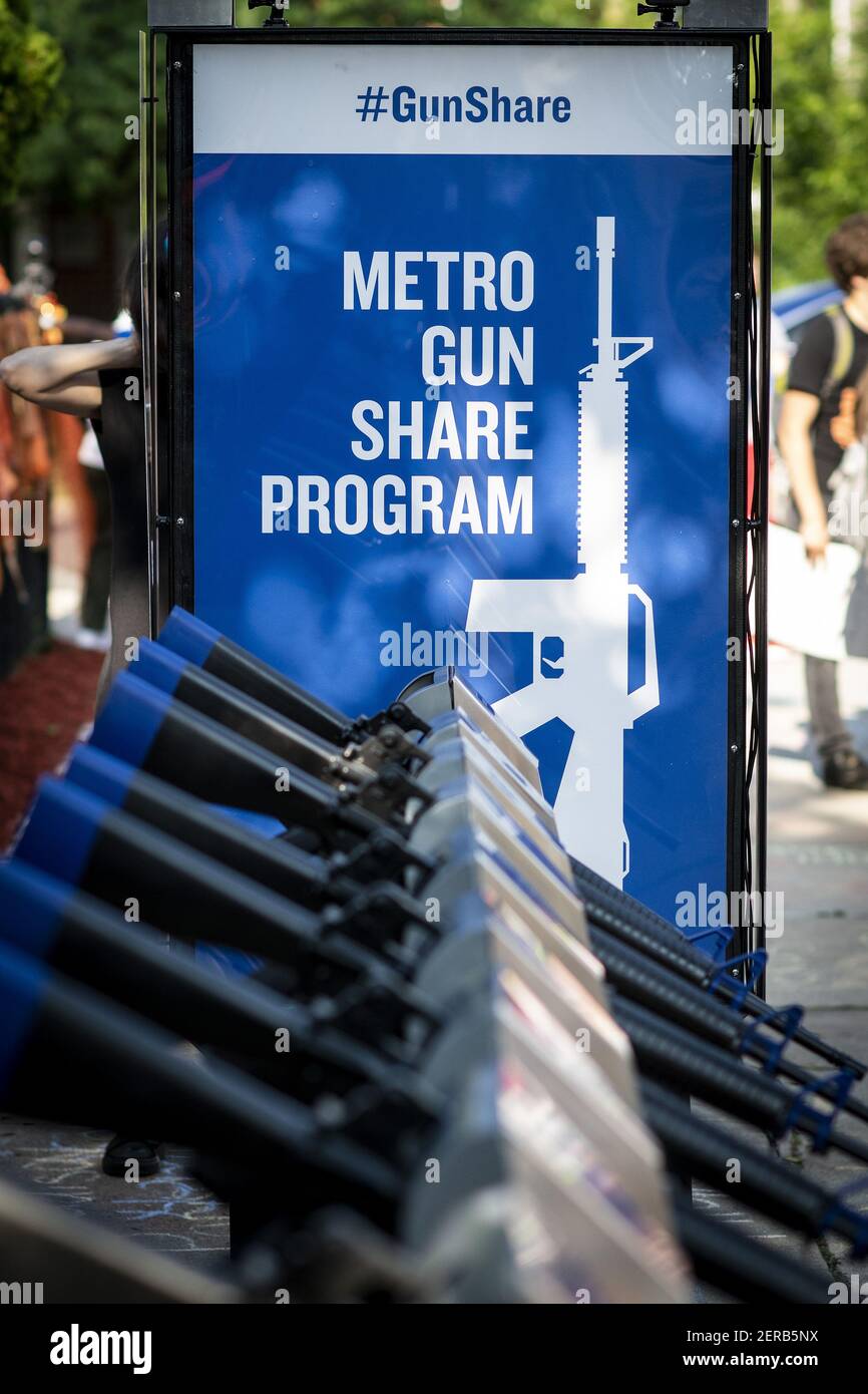 An art installation of mock AR-15 rifles, designed in a manner similar ...