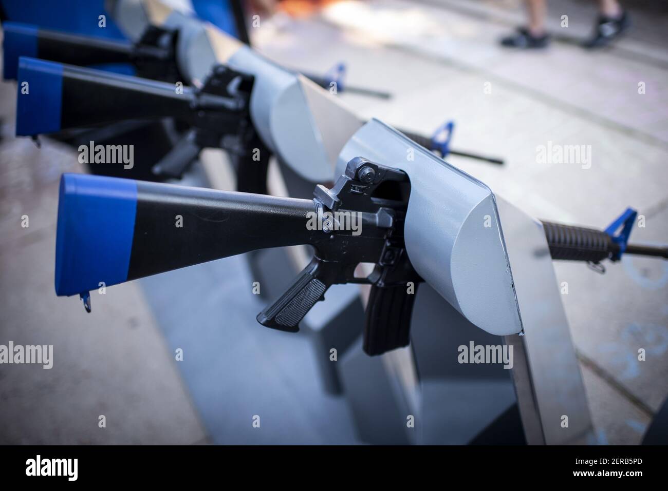 An art installation of mock AR-15 rifles, designed in a manner similar ...