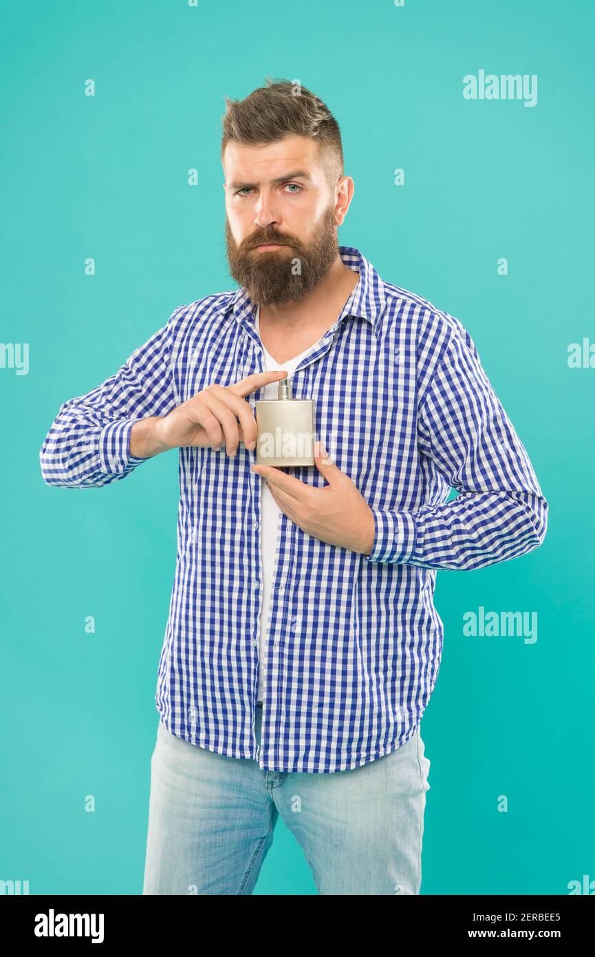 trendy caucasian guy with beard and mustache presenting male perfume on ...