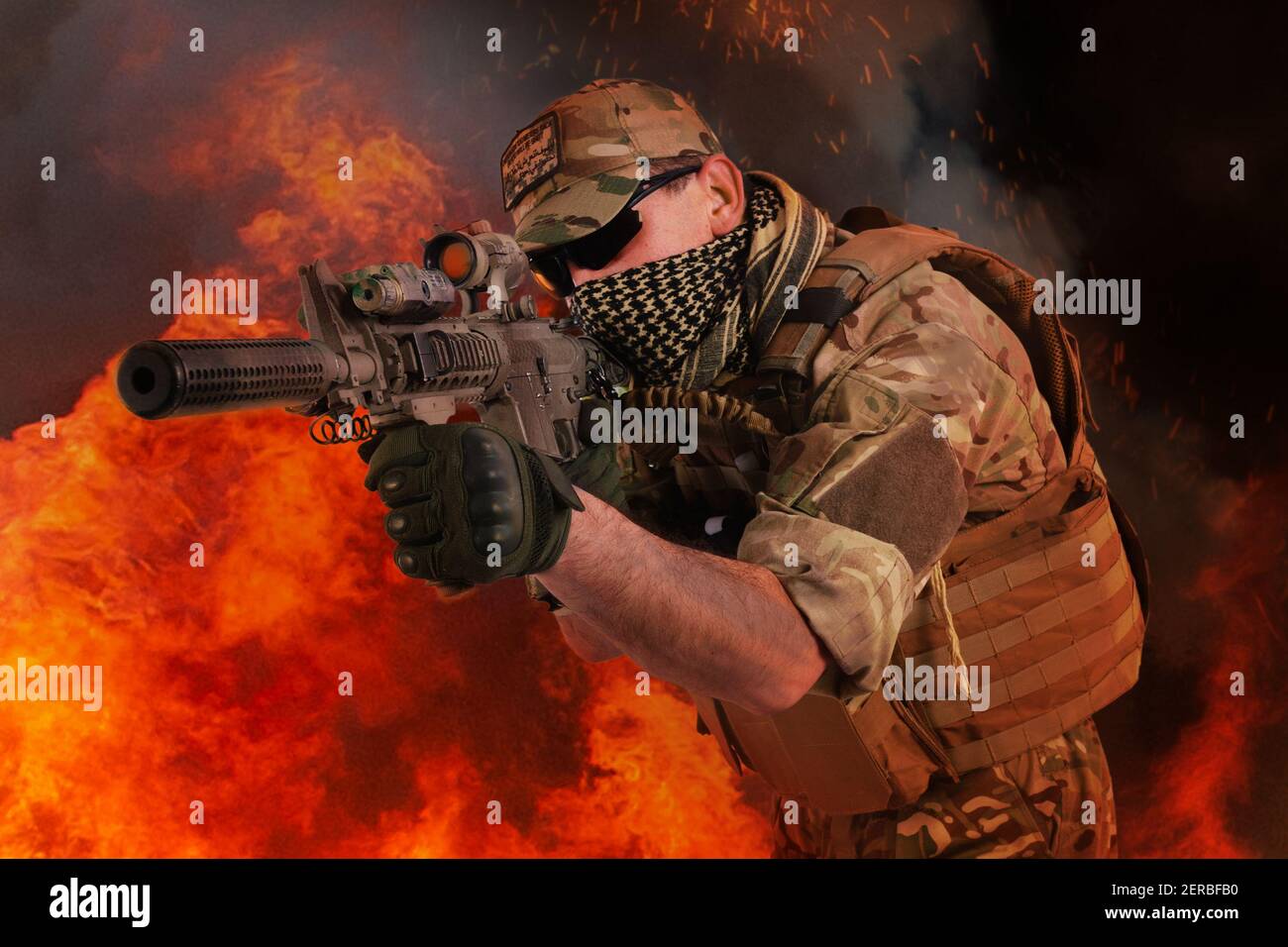 Soldier of special forces with carbine M4 in action. Flame and smoke on ...