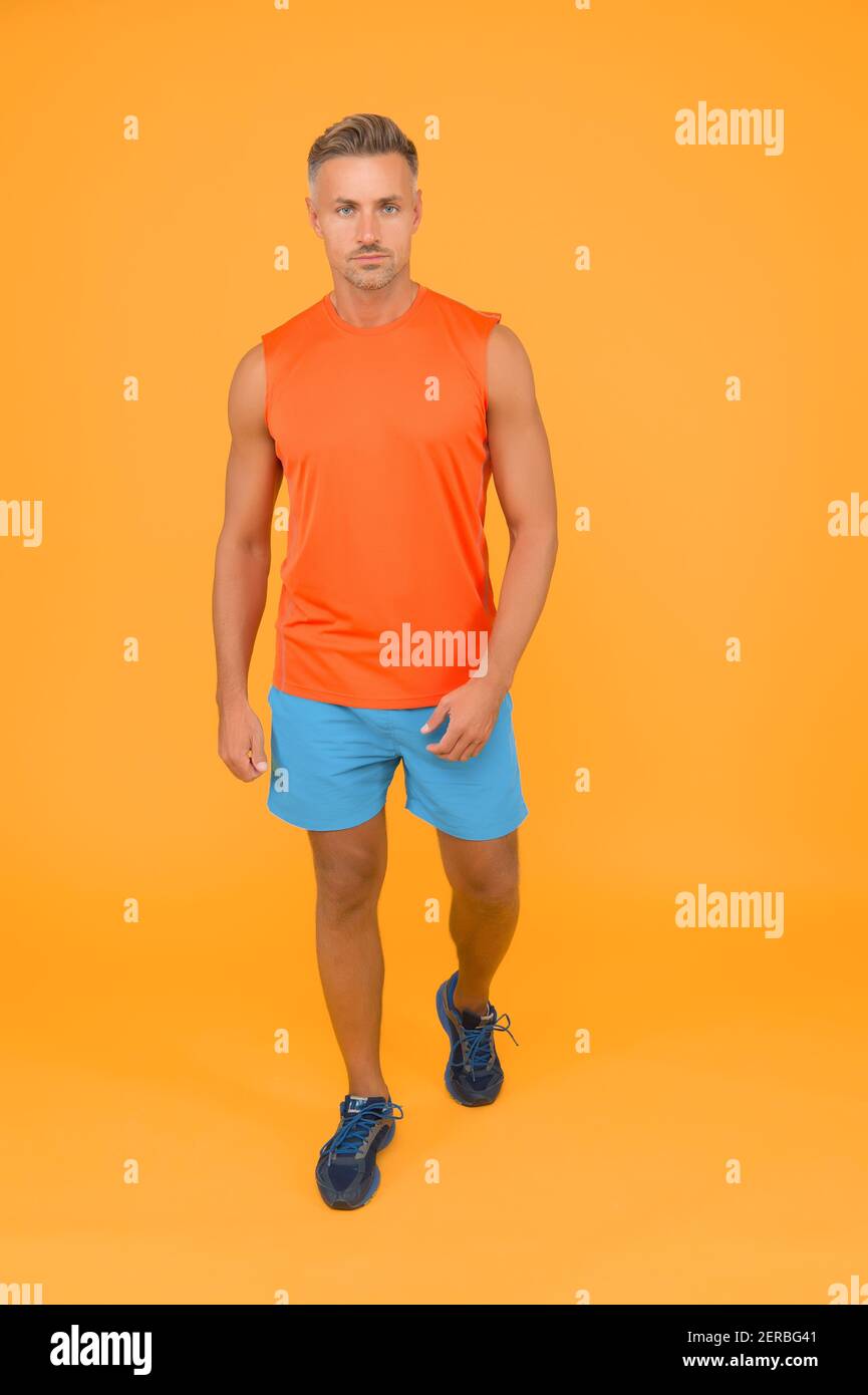 Train all your muscles. Muscular man yellow background. Fit athlete in ...