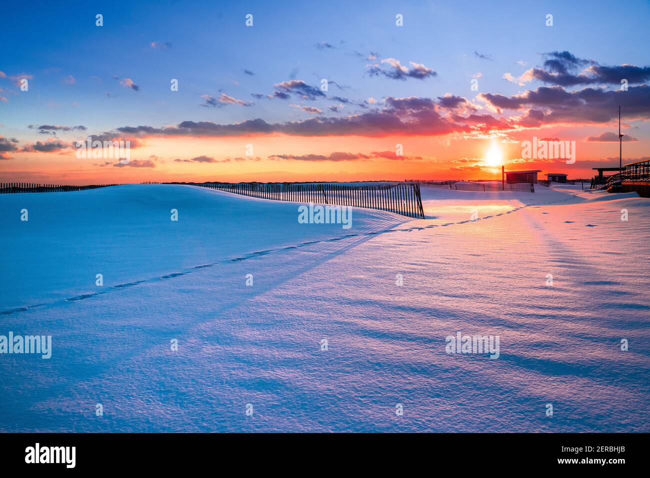 Winter scene under color sky at sunset on snow covered beach. Jones ...
