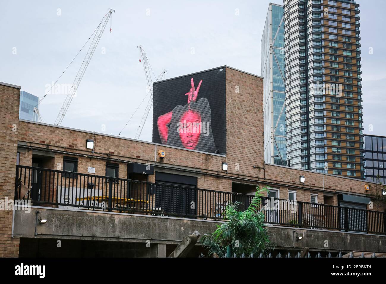 London, UK. 14 Feb 2021. Neon style graffiti of a woman by artist David ...
