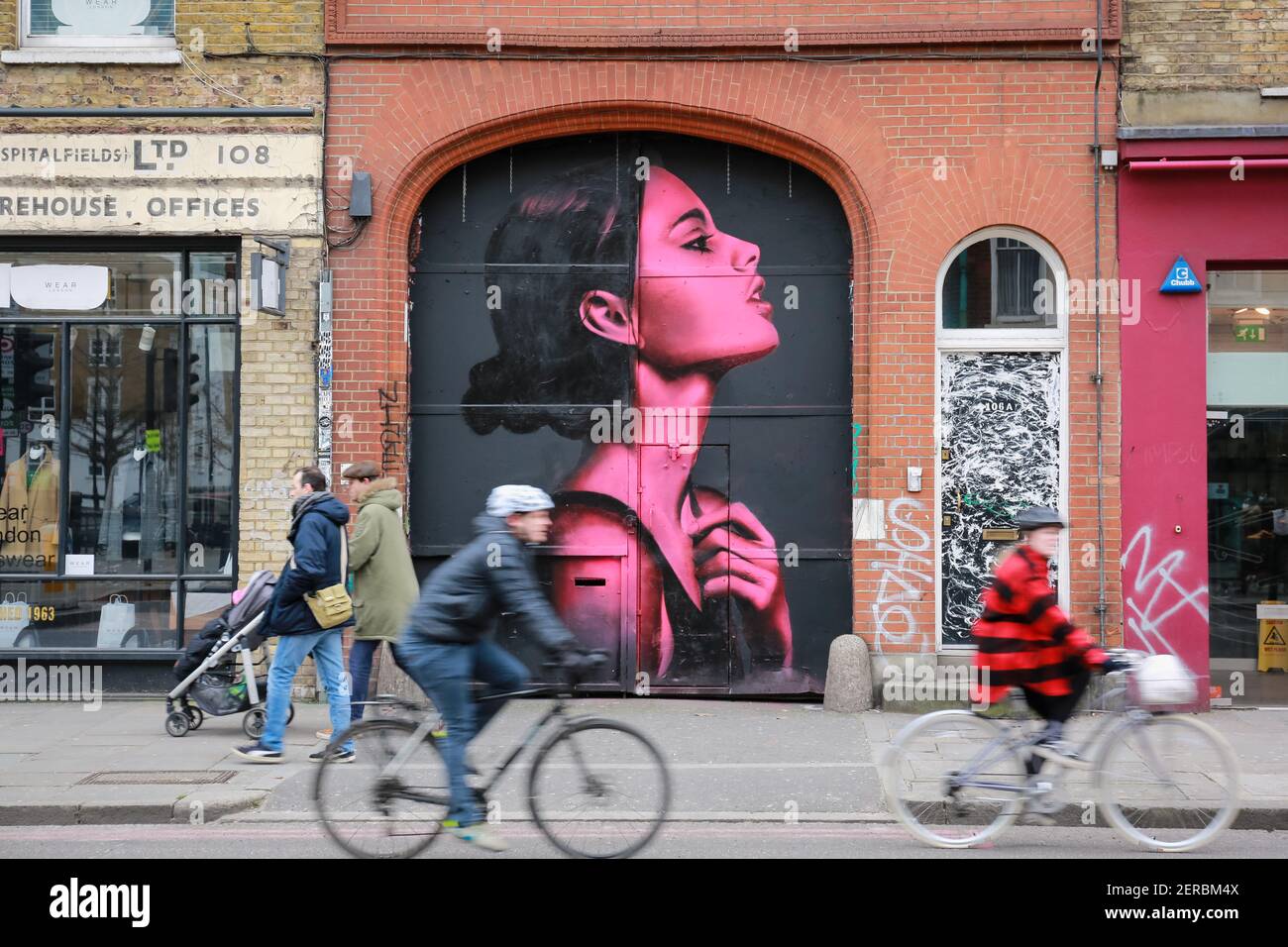 London, UK. 14 Feb 2021. Neon style graffiti of a woman by artist David ...