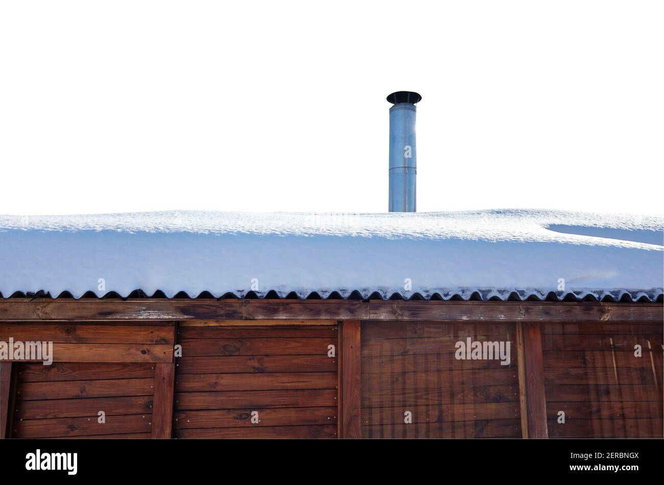 Wooden block house with snow covered roof and chimney isolated on white ...