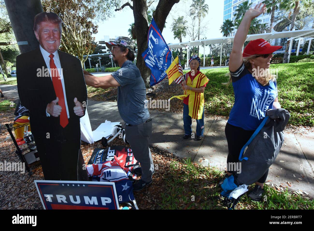 Nelson Ngo ties a cardboard cutout of former President Donald Trump at ...