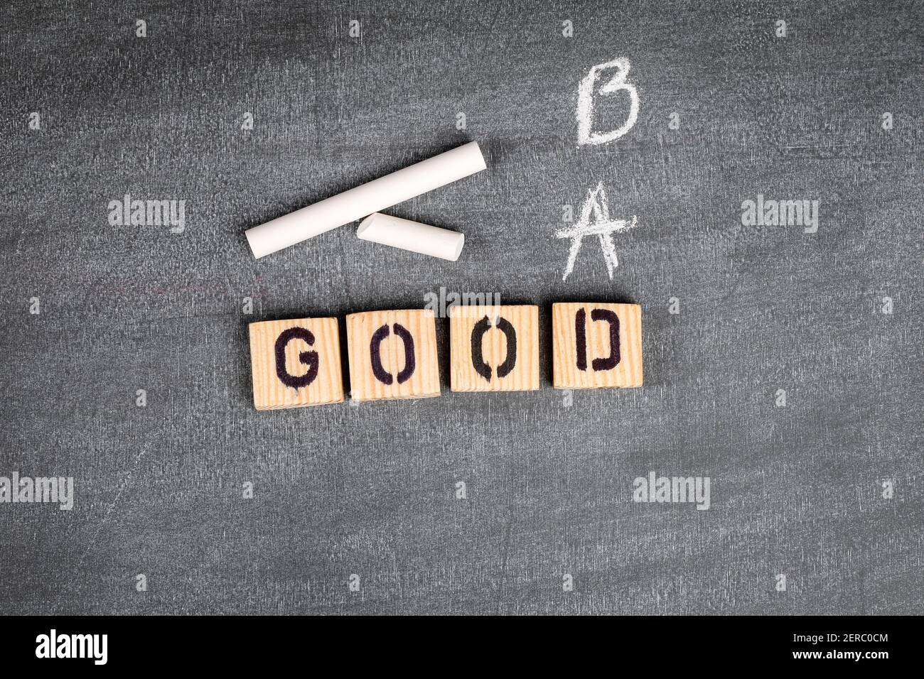 Good and Bad concept. Wooden alphabet letters on a gray chalk board ...