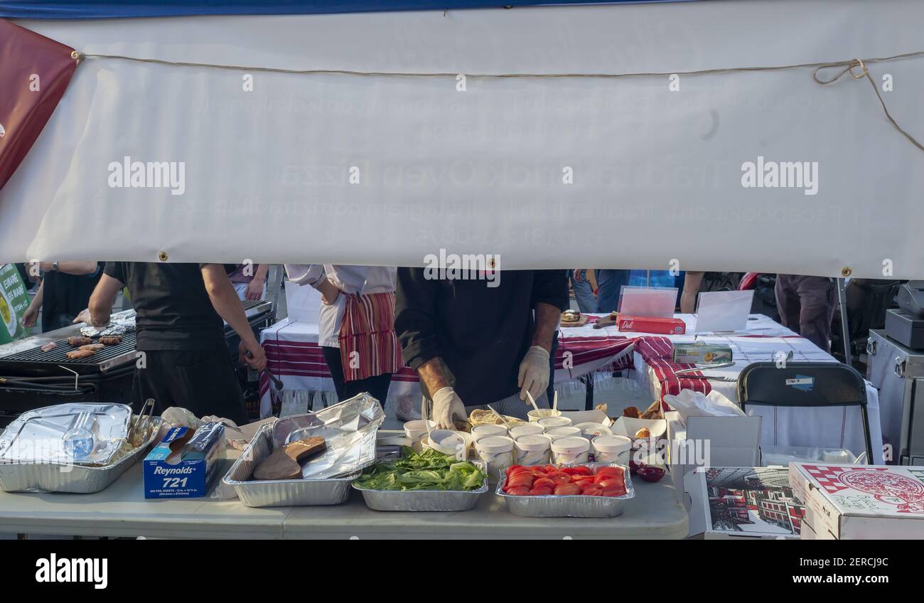 Food preparation during the opening evening of the Bronx Night Market ...