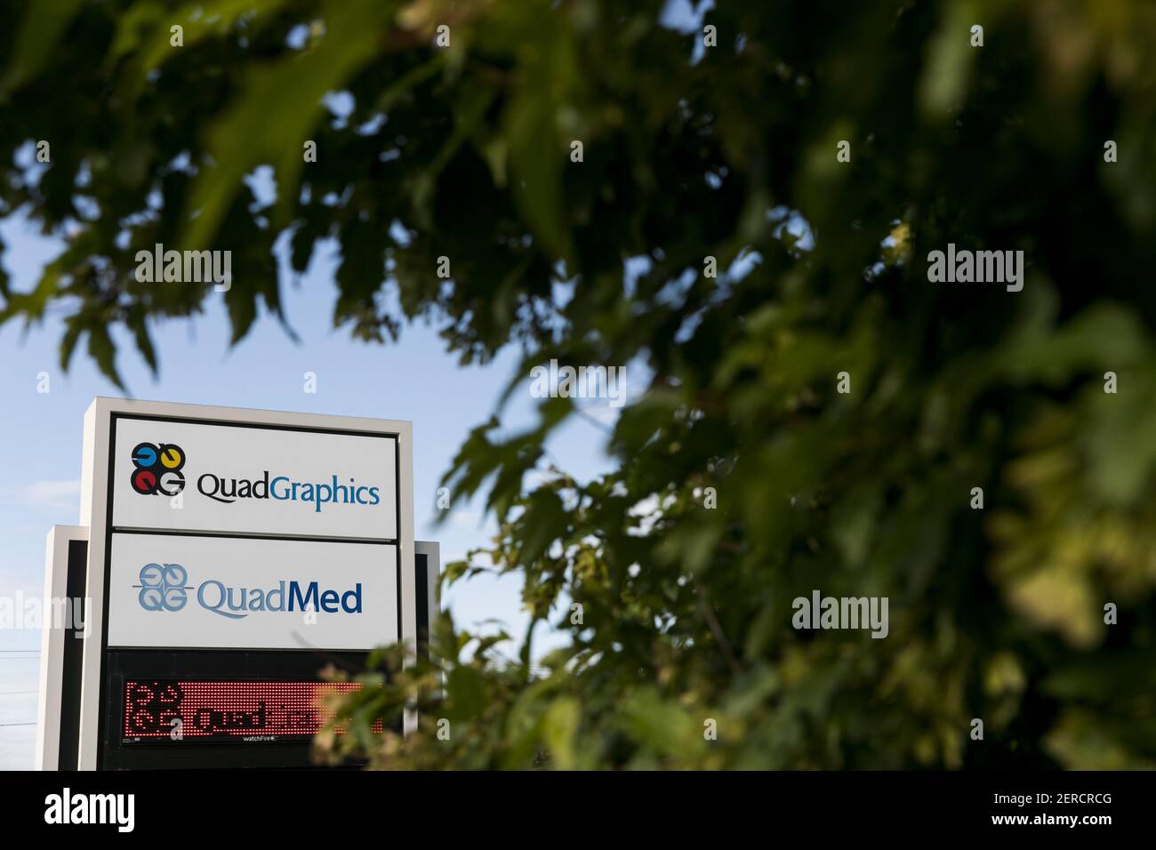 A logo sign outside of a facility occupied by QuadGraphics and QuadMed ...
