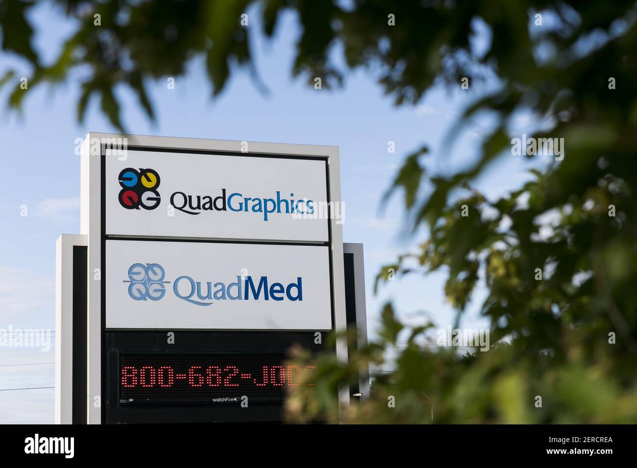 A logo sign outside of a facility occupied by QuadGraphics and QuadMed ...