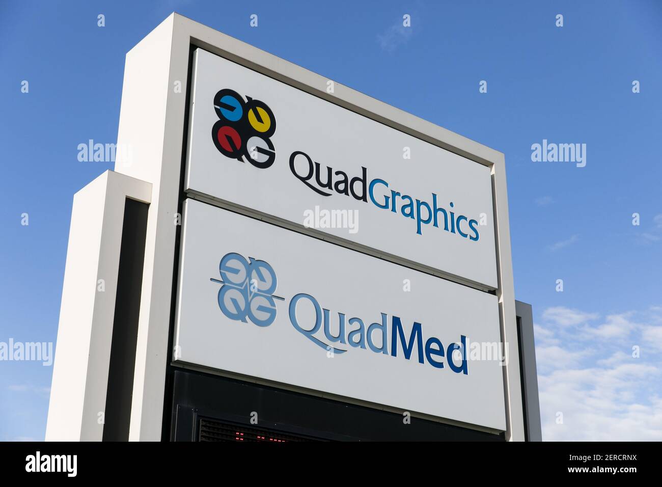 A logo sign outside of a facility occupied by QuadGraphics and QuadMed ...