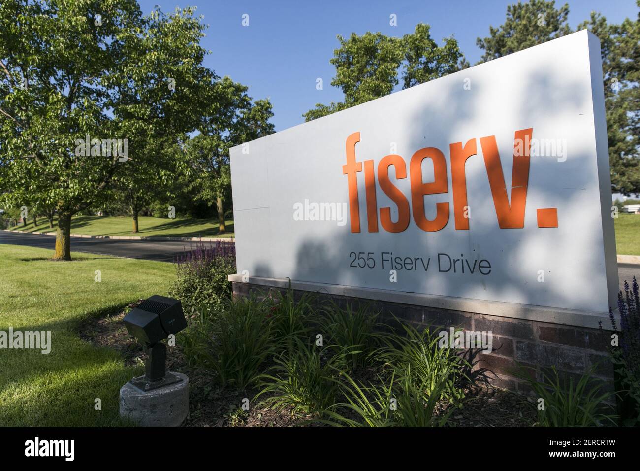 A logo sign outside of the headquarters of Fiserv, Inc., in Brookfield ...