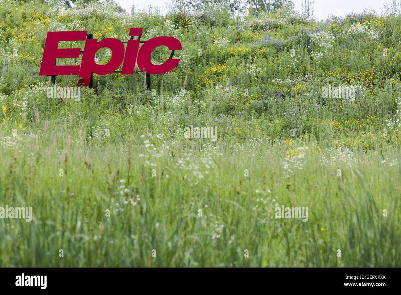 A logo sign outside of the headquarters of the Epic Systems Corporation ...