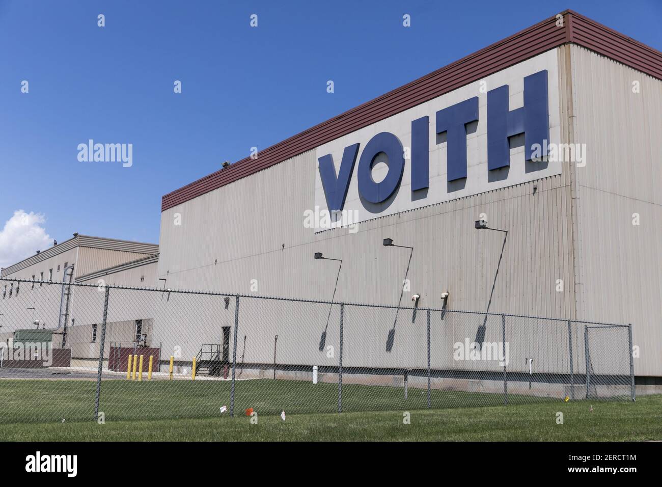 A logo sign outside of a facility occupied by Voith GmbH & Co., in ...