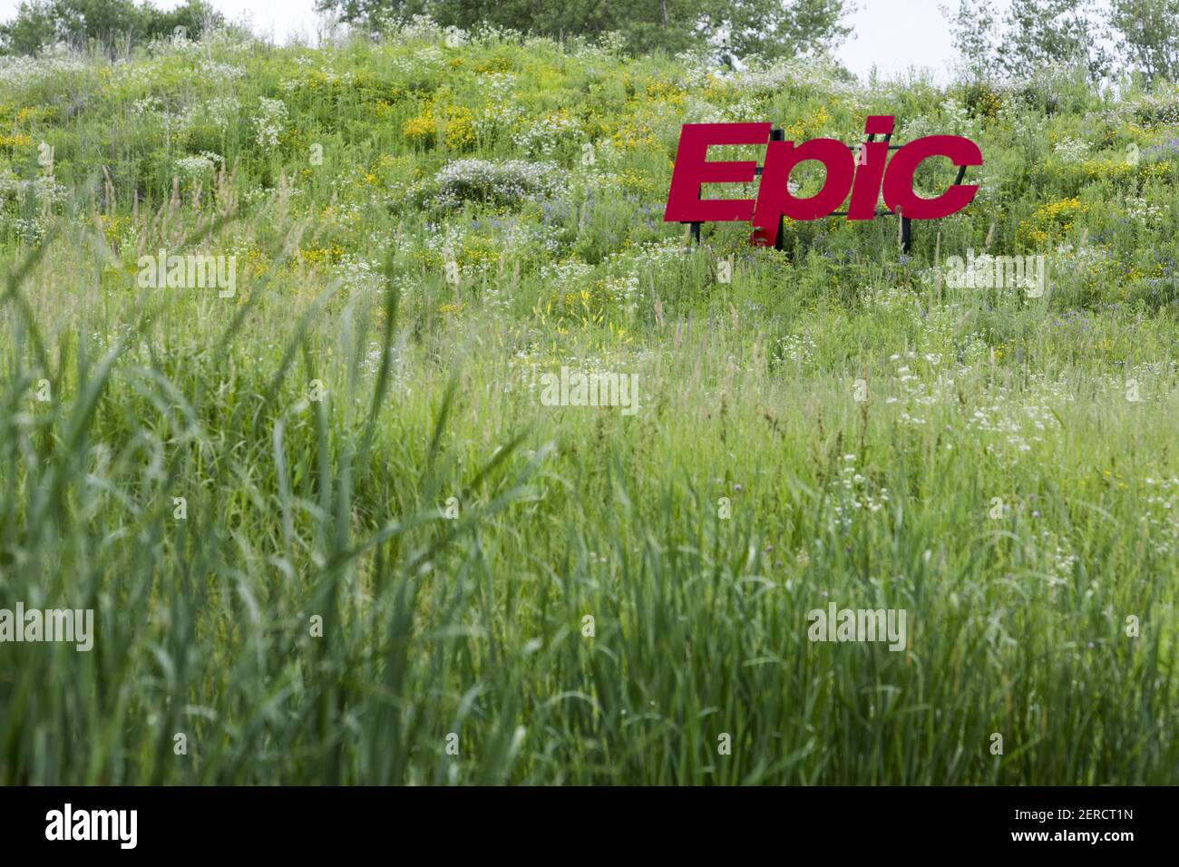 A logo sign outside of the headquarters of the Epic Systems Corporation ...