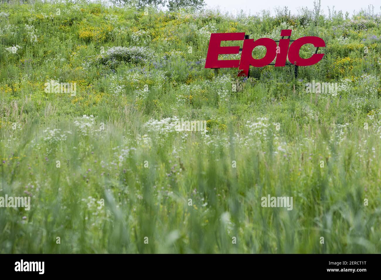 A logo sign outside of the headquarters of the Epic Systems Corporation ...
