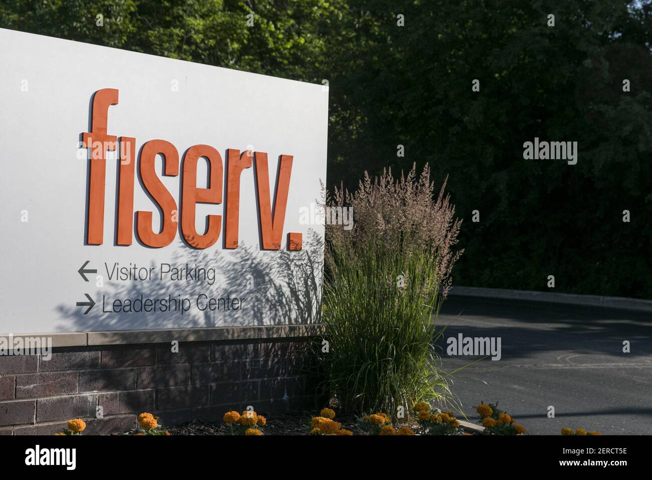 A logo sign outside of the headquarters of Fiserv, Inc., in Brookfield ...