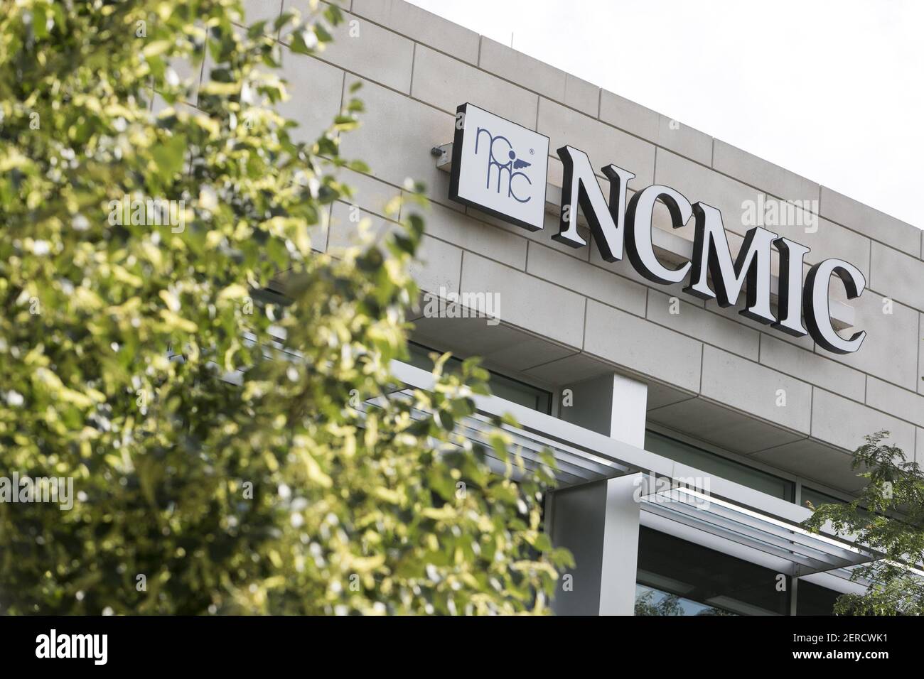 A logo sign outside of the headquarters of the NCMIC Group, Inc., in ...