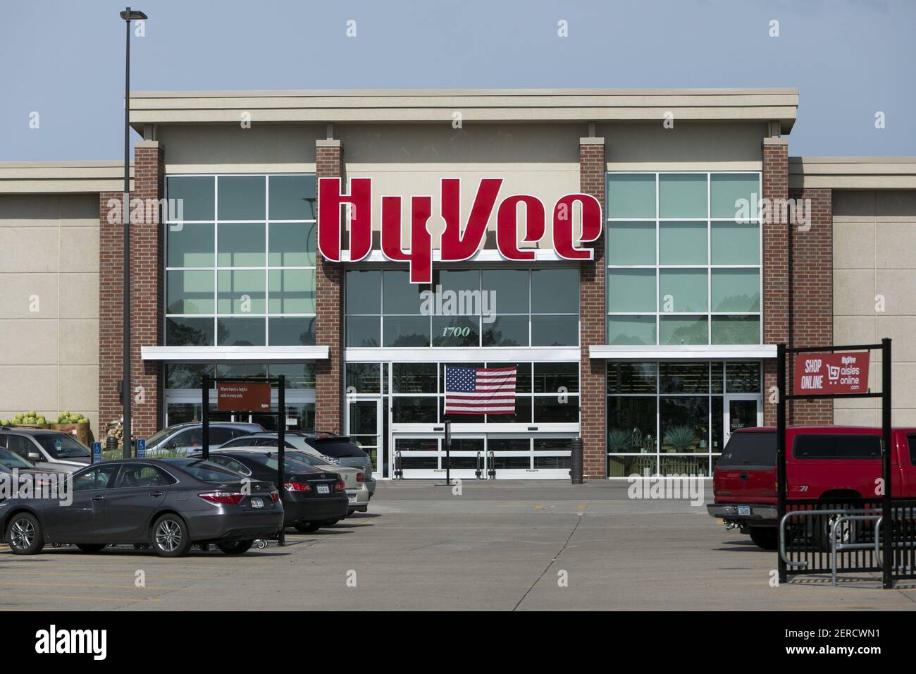 A logo sign outside of a Hy-Vee retail grocery store in West Des Moines ...